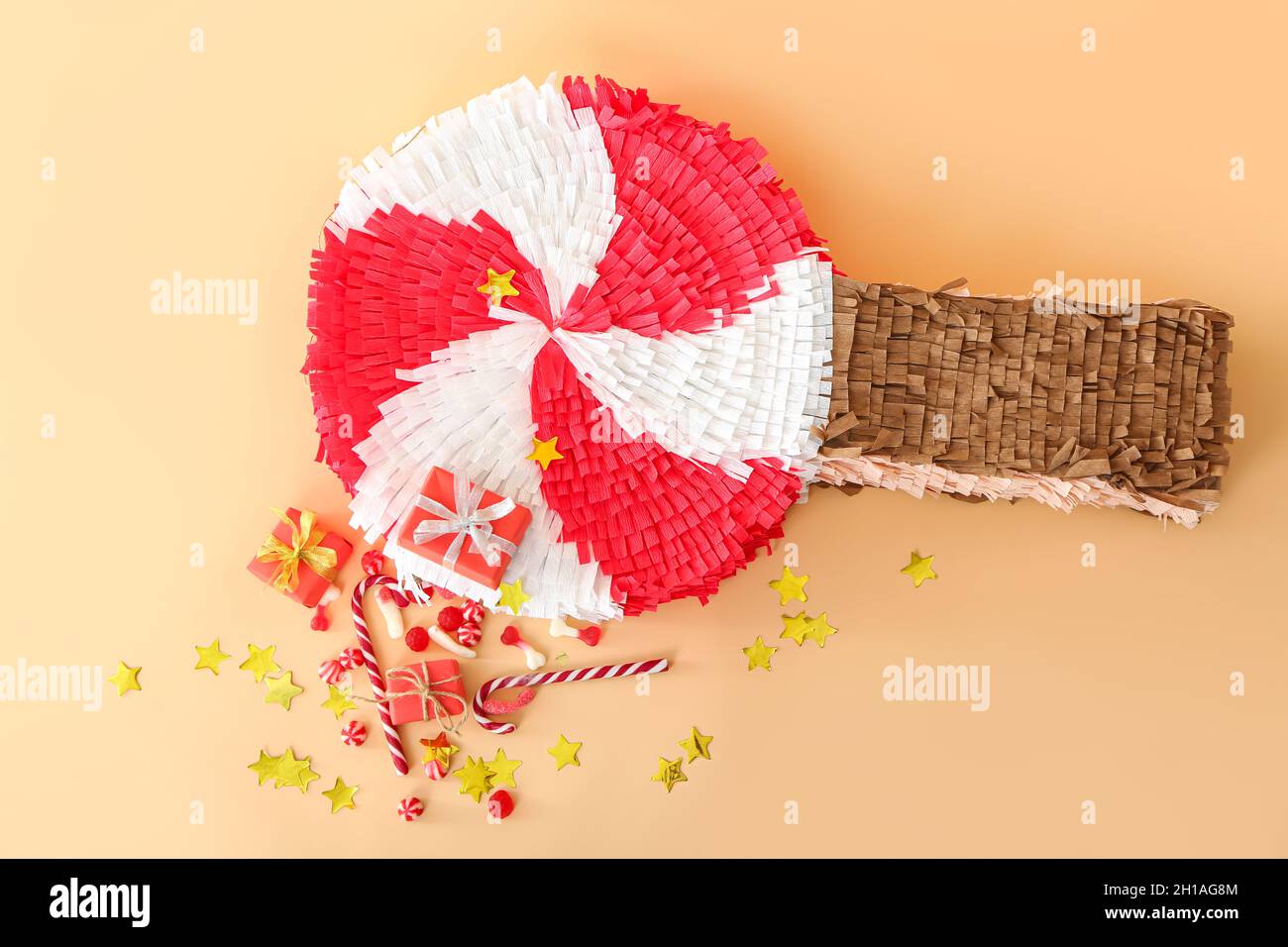 Mexican pinata with gifts and candies on color background Stock Photo ...