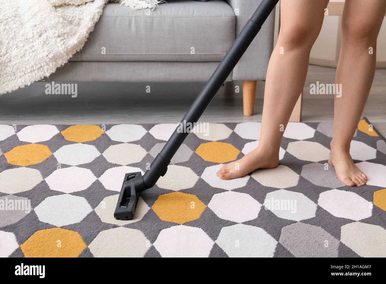 Female housekeeper vacuuming floor in hi-res stock photography and ...