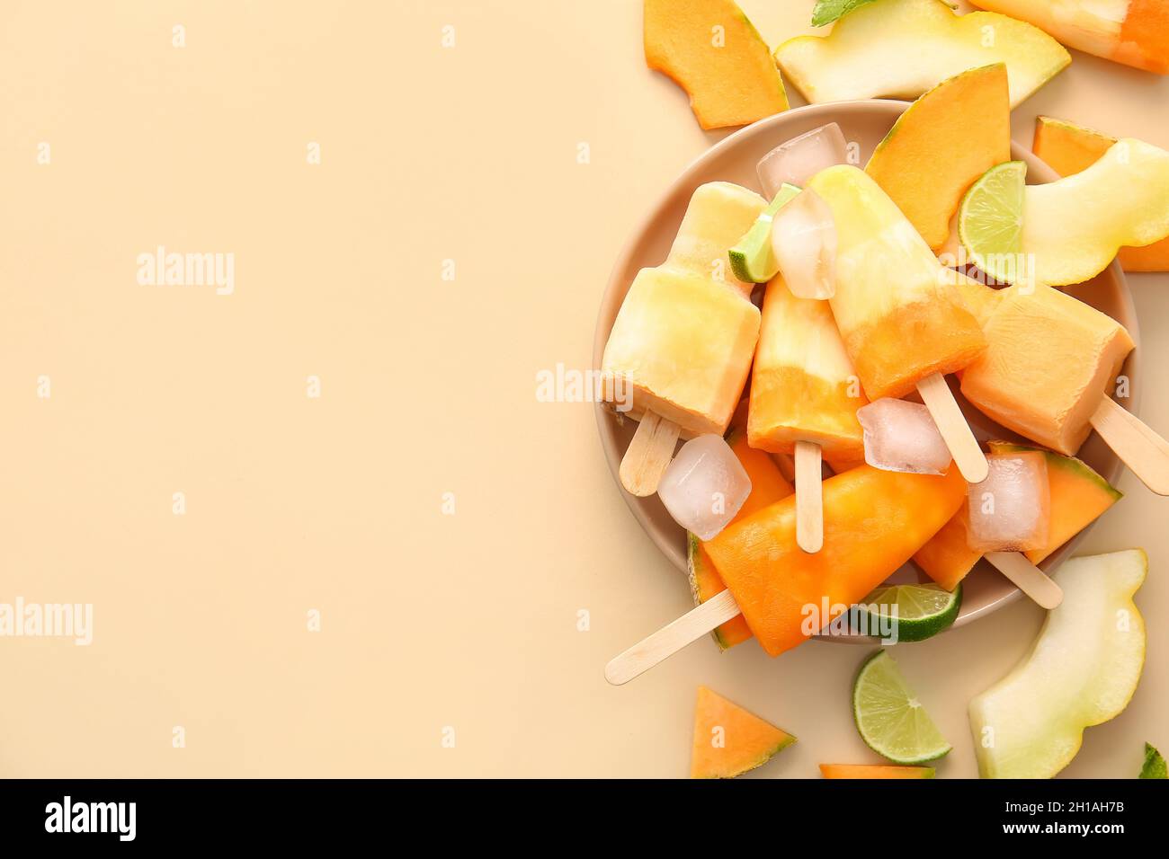 Plate with tasty melon popsicles on color background Stock Photo - Alamy