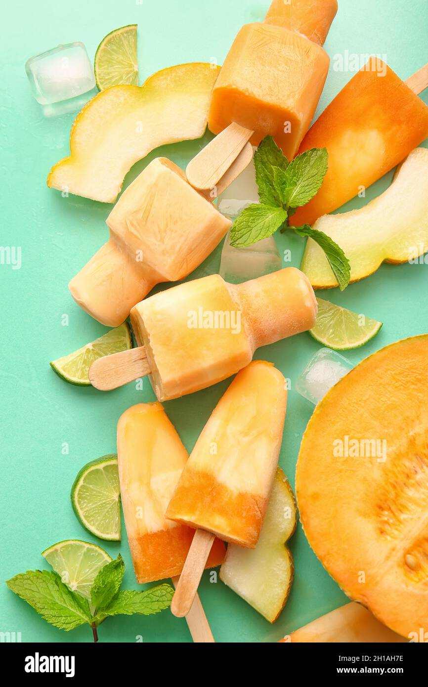 Tasty melon popsicles on color background Stock Photo - Alamy