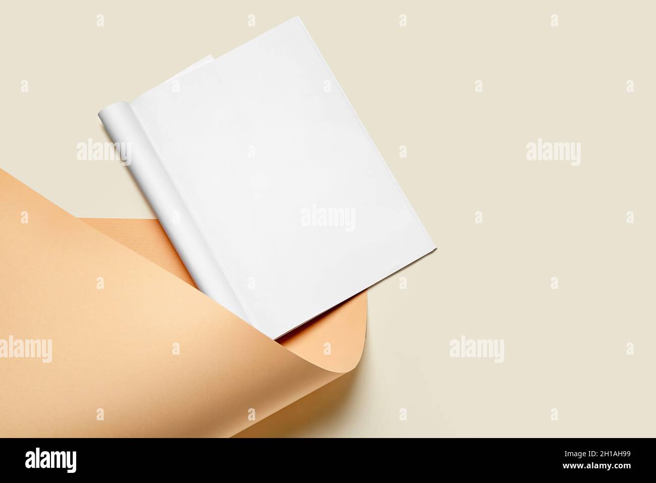 Open blank magazine on yellow background Stock Photo - Alamy