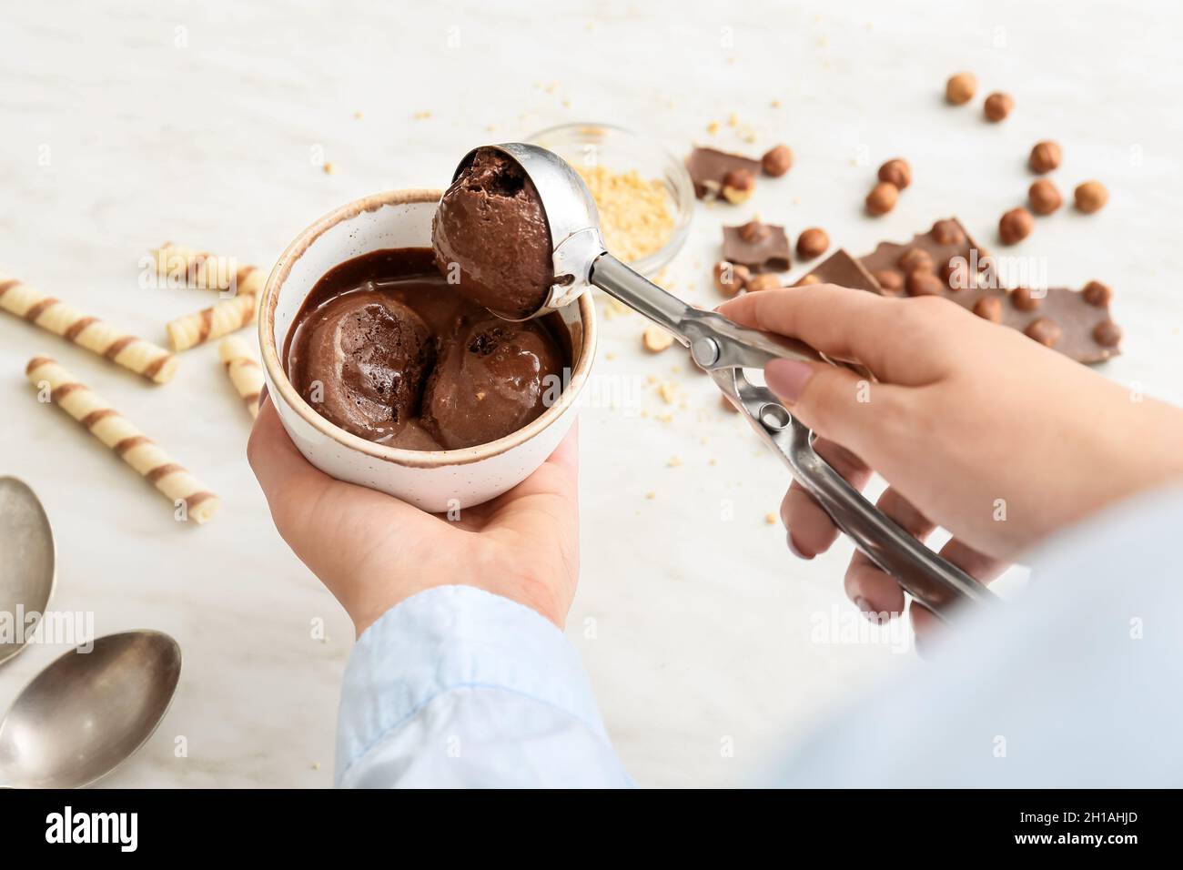 Woman preparing tasty chocolate ice cream on white background Stock ...