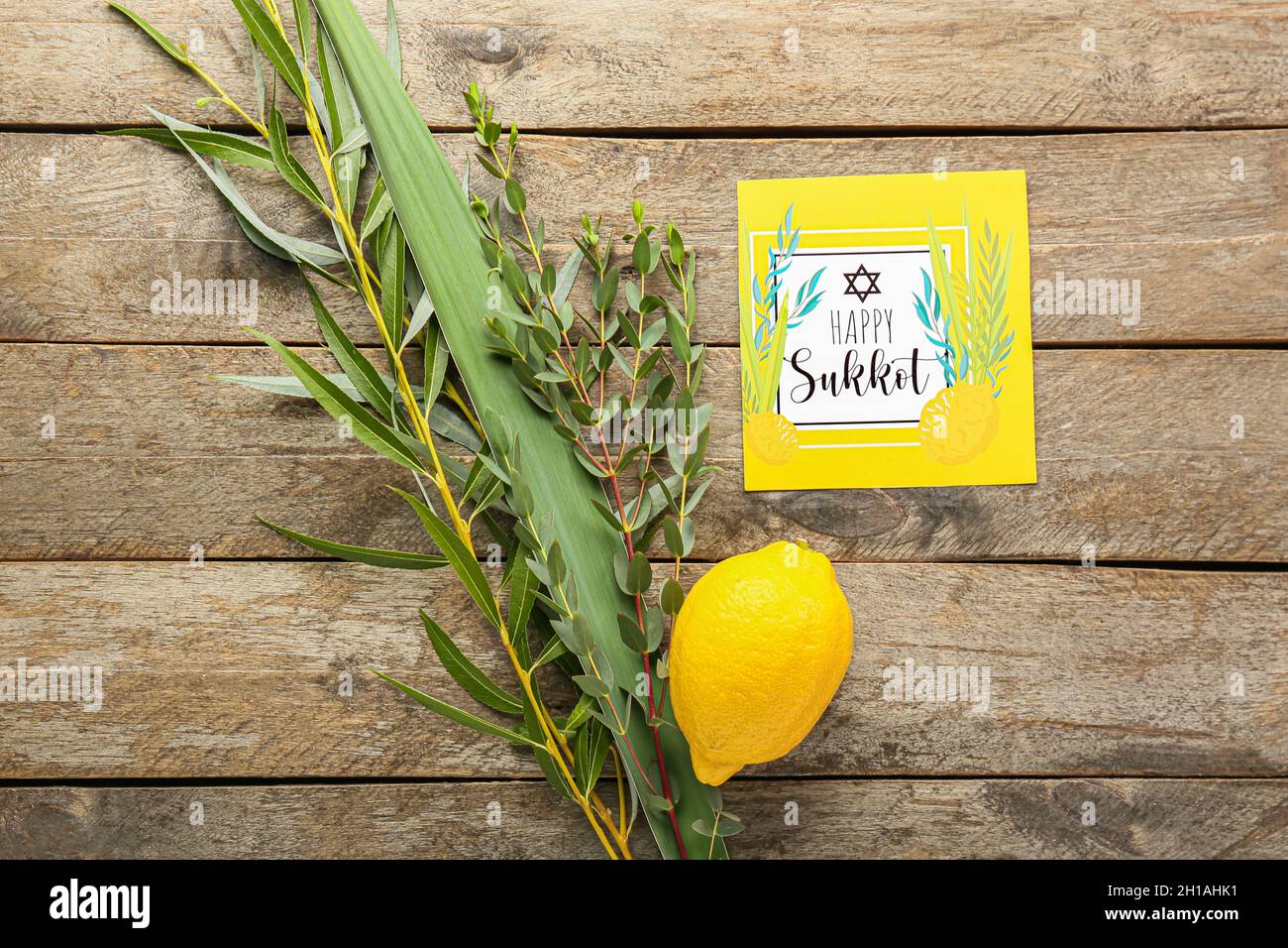 Sukkot festival symbols and greeting card on wooden background Stock ...