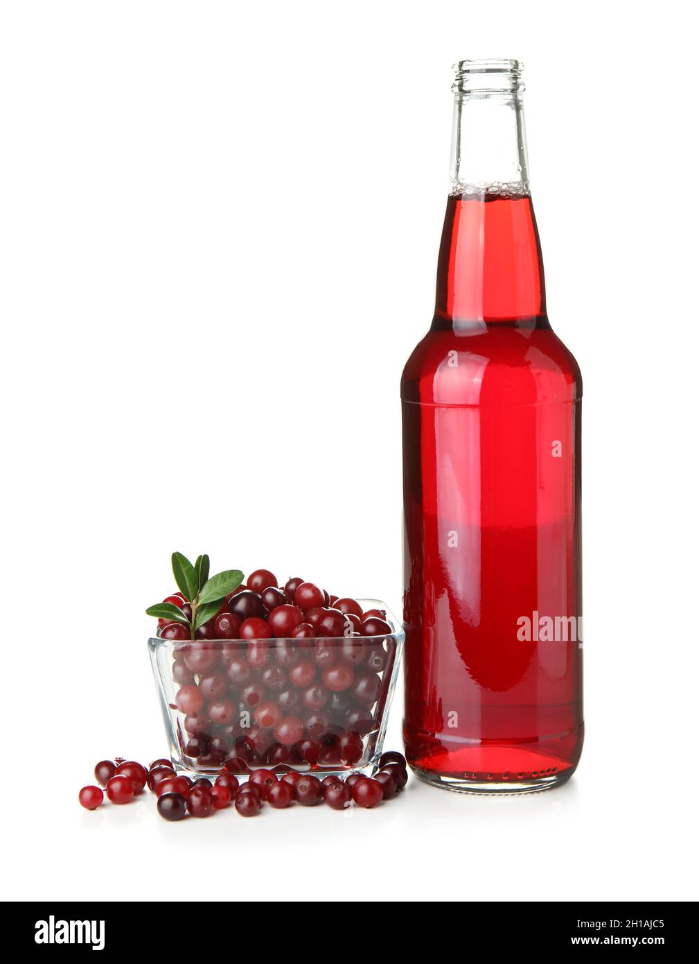 Bottle of healthy juice and bowl with cranberries on white background ...