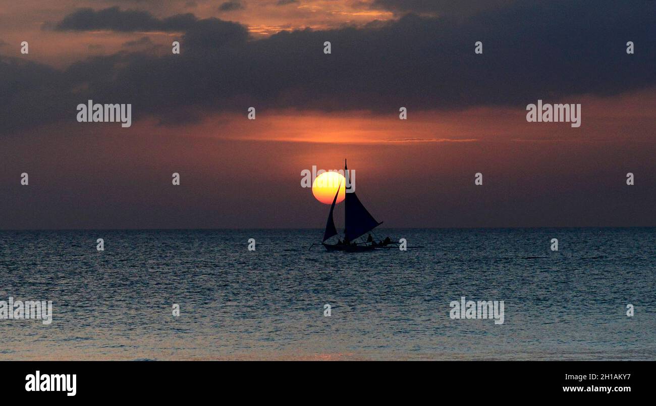 A romantic sunset enjoyed from the beach in Boracay island, Aklan ...