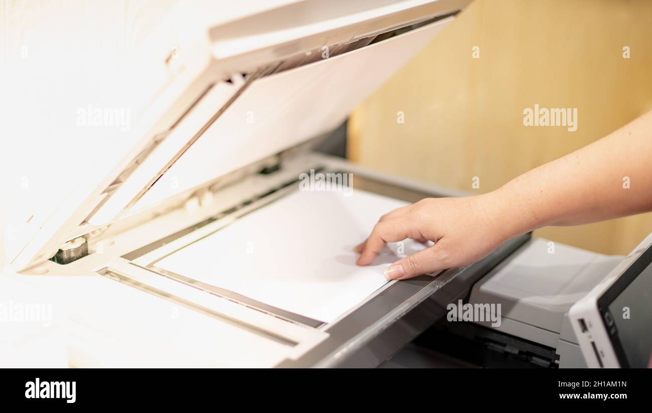 Business woman hand lay down or take papers from laser copy machine for ...