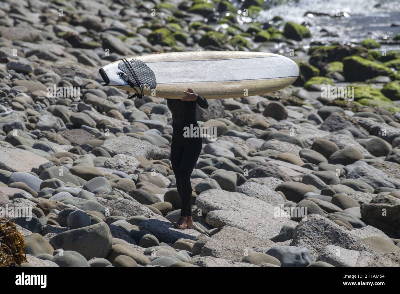 Woman carrying a surfboard over the head by Ventura Beach Stock Photo ...
