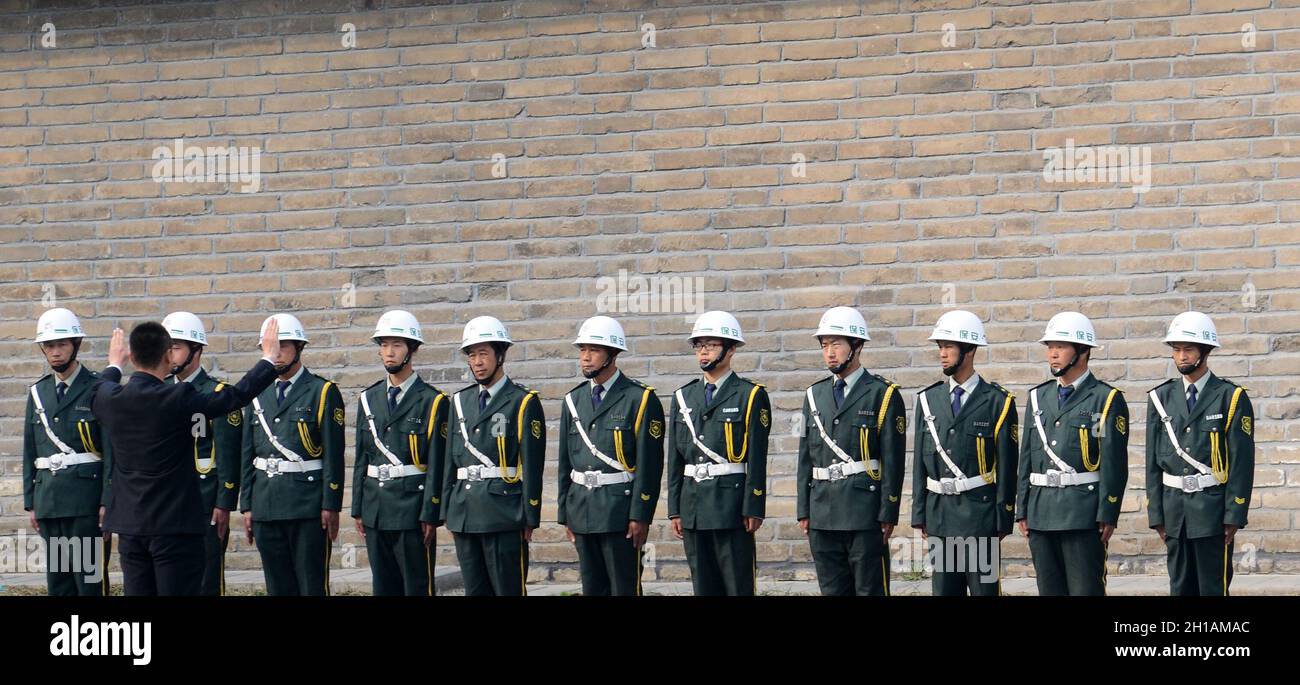 Chinese security forces standing in strait line during an order by ...