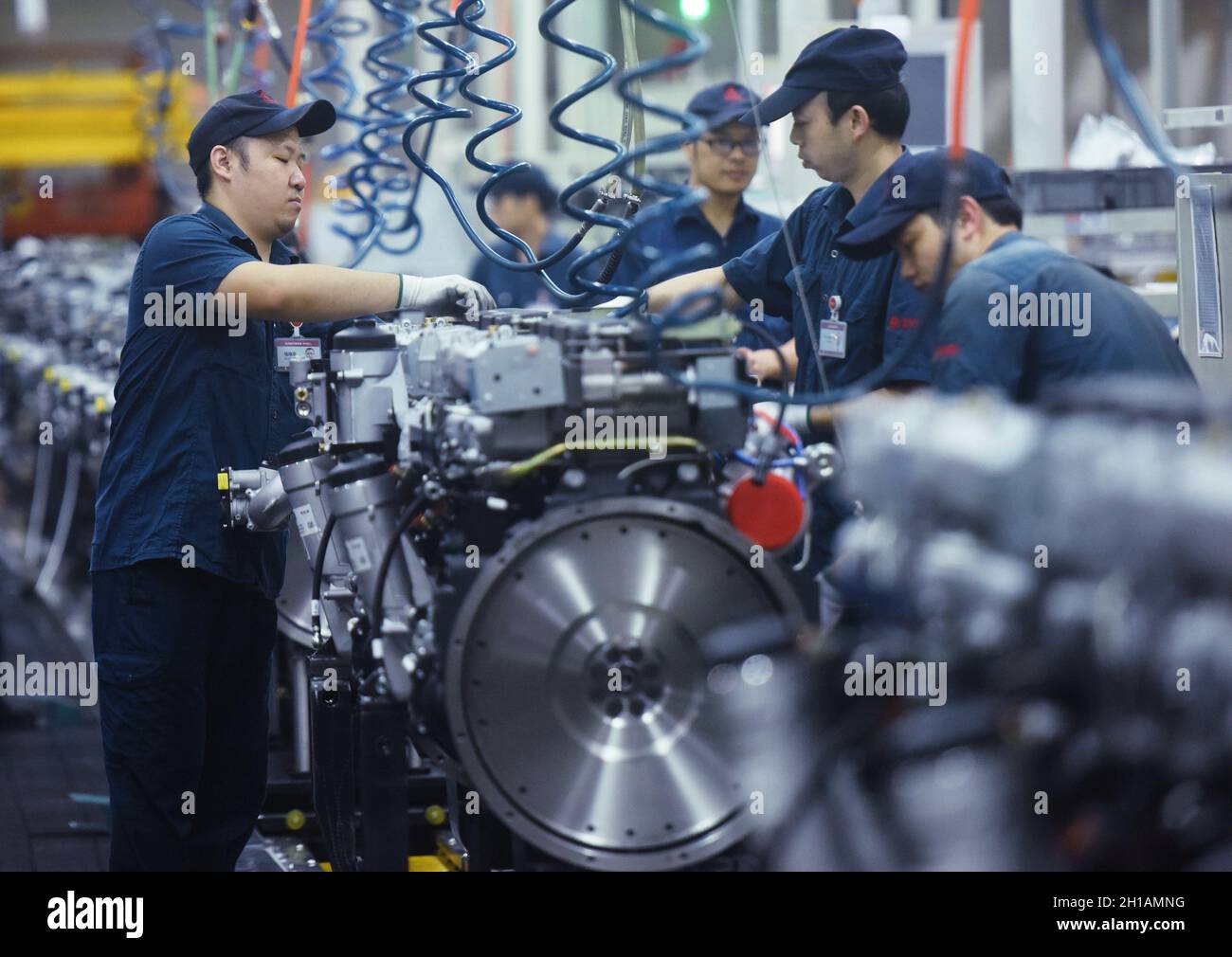 HANGZHOU, CHINA - OCTOBER 18, 2021 - Workers assemble heavy truck ...