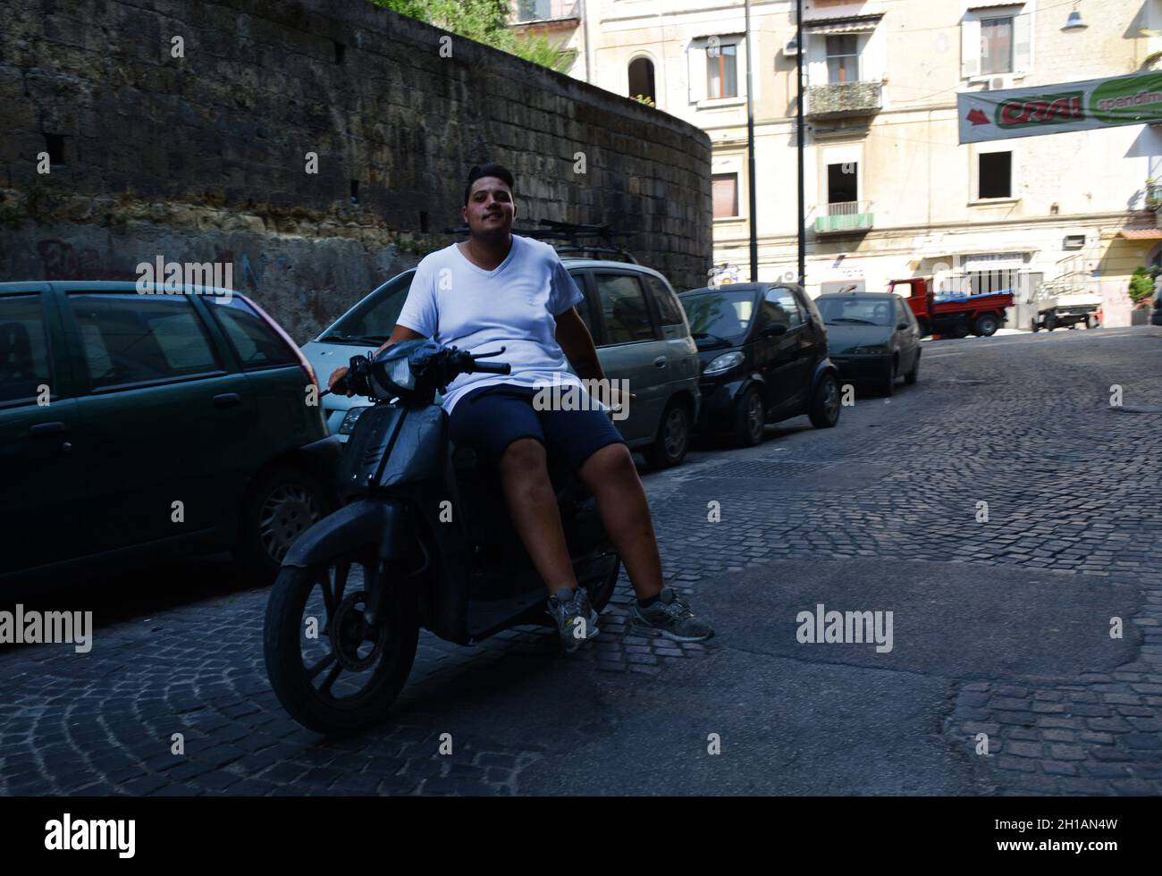 A young Italian man sitting on a scooter in Naples, Italy Stock Photo ...