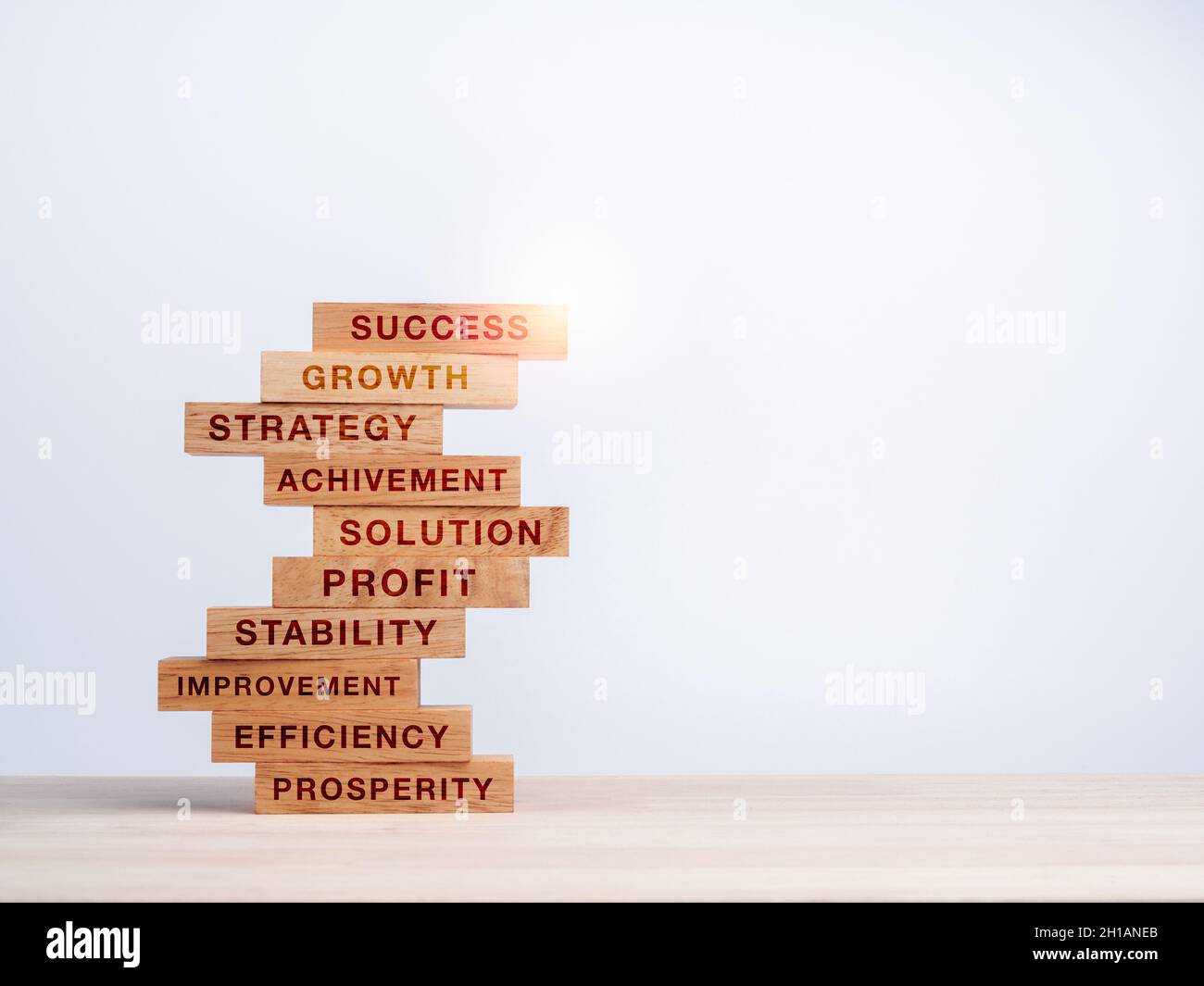 Business strategy, keywords on wooden block sticks stack on wooden desk ...