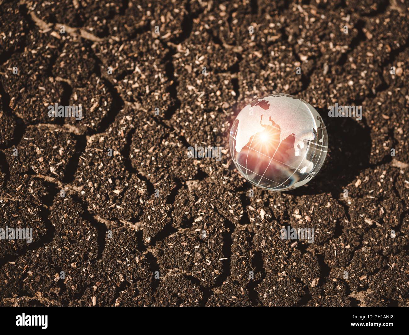 Glass globe on brown dried crack soil land background, top view ...