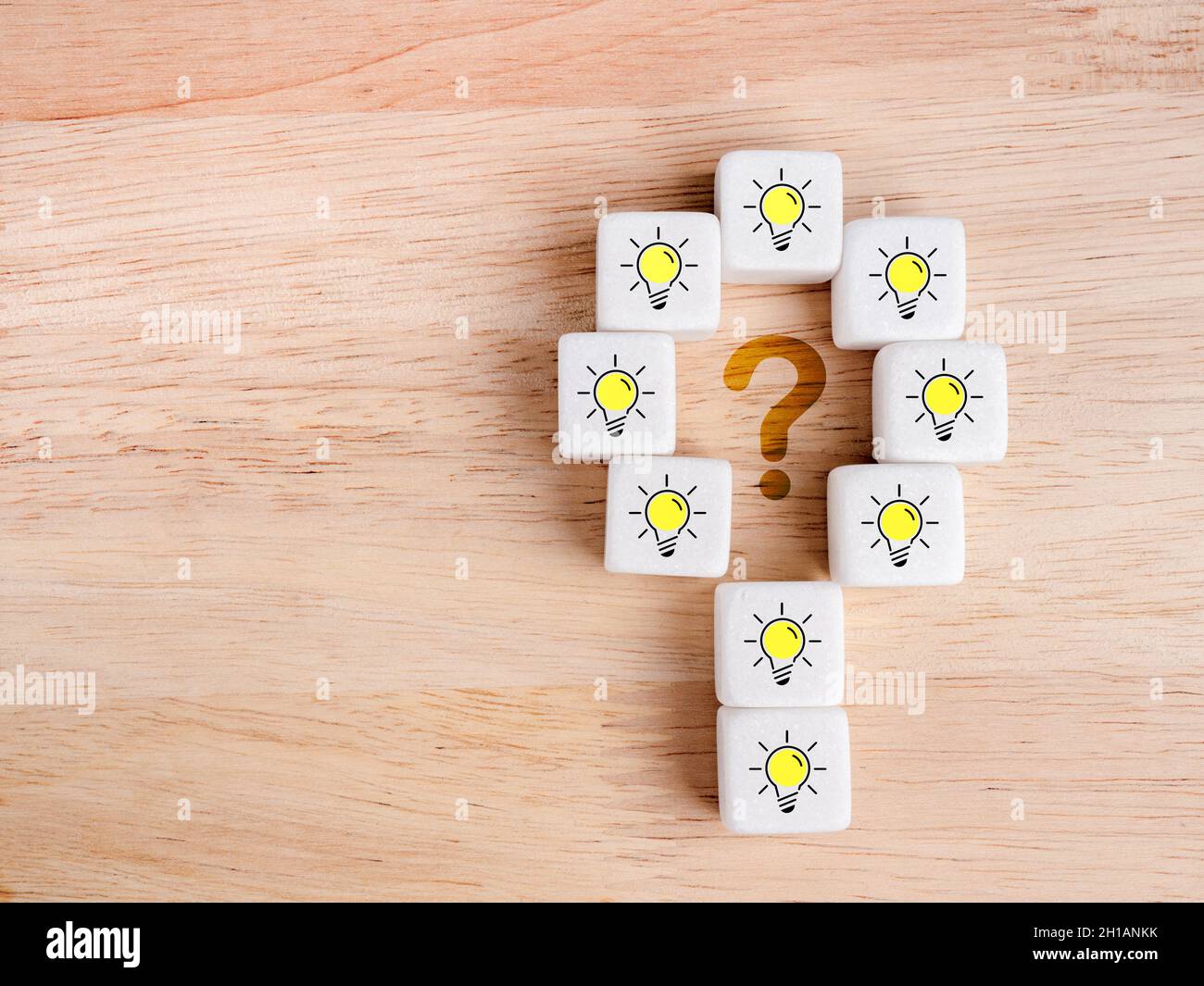 Light bulb with yellow light, the icon on white dices around question ...