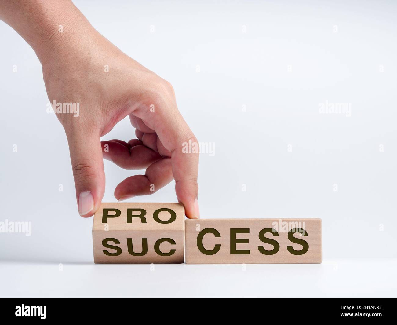 Process for success concept. Hand turning wooden cube block to change ...