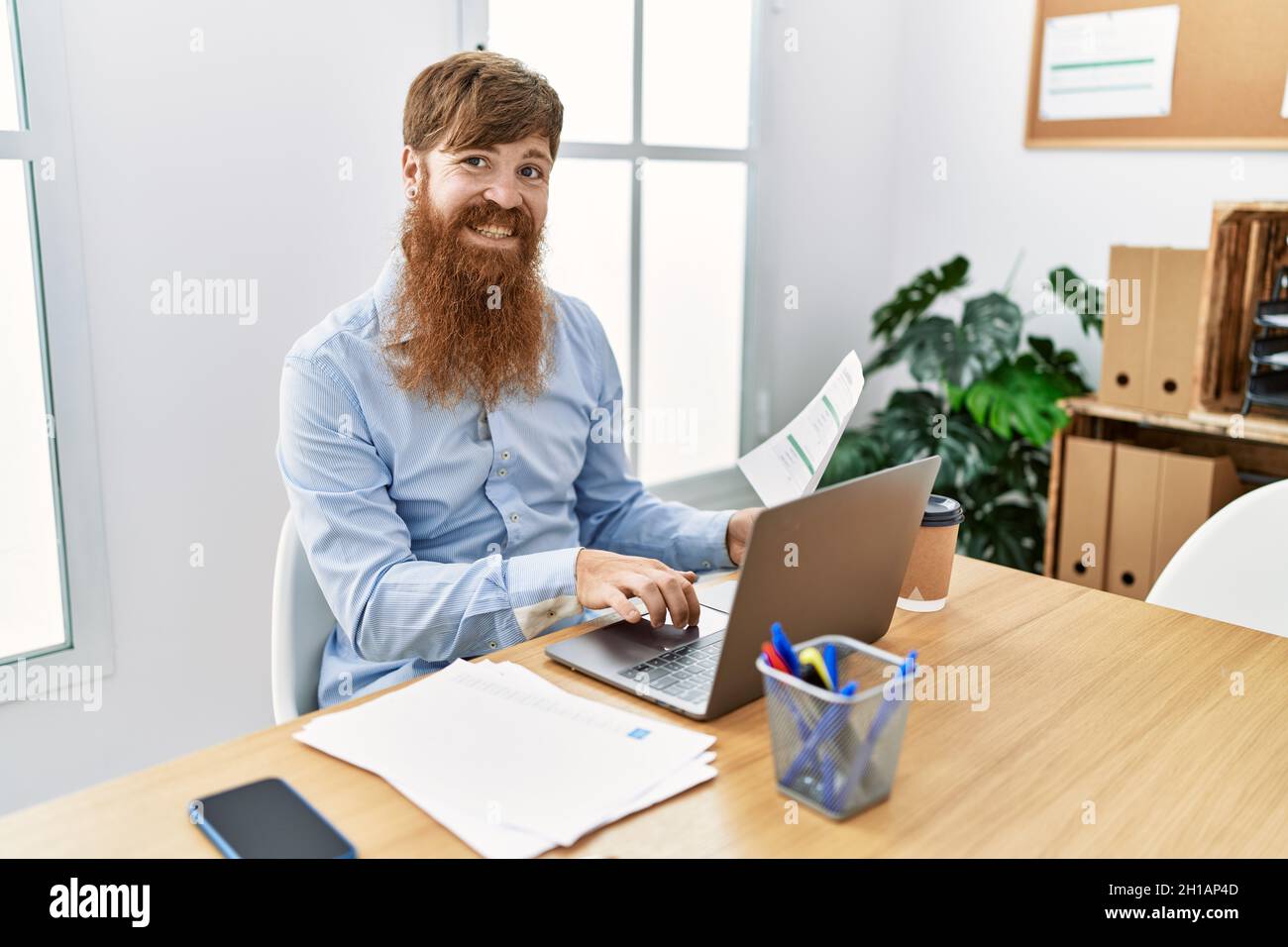 Young irish businessman smiling happy working at the office Stock Photo ...