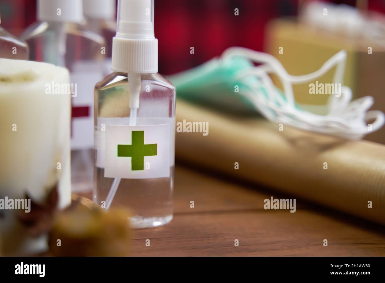 Alcohol antiseptic with the green cross logo on wooden background ...