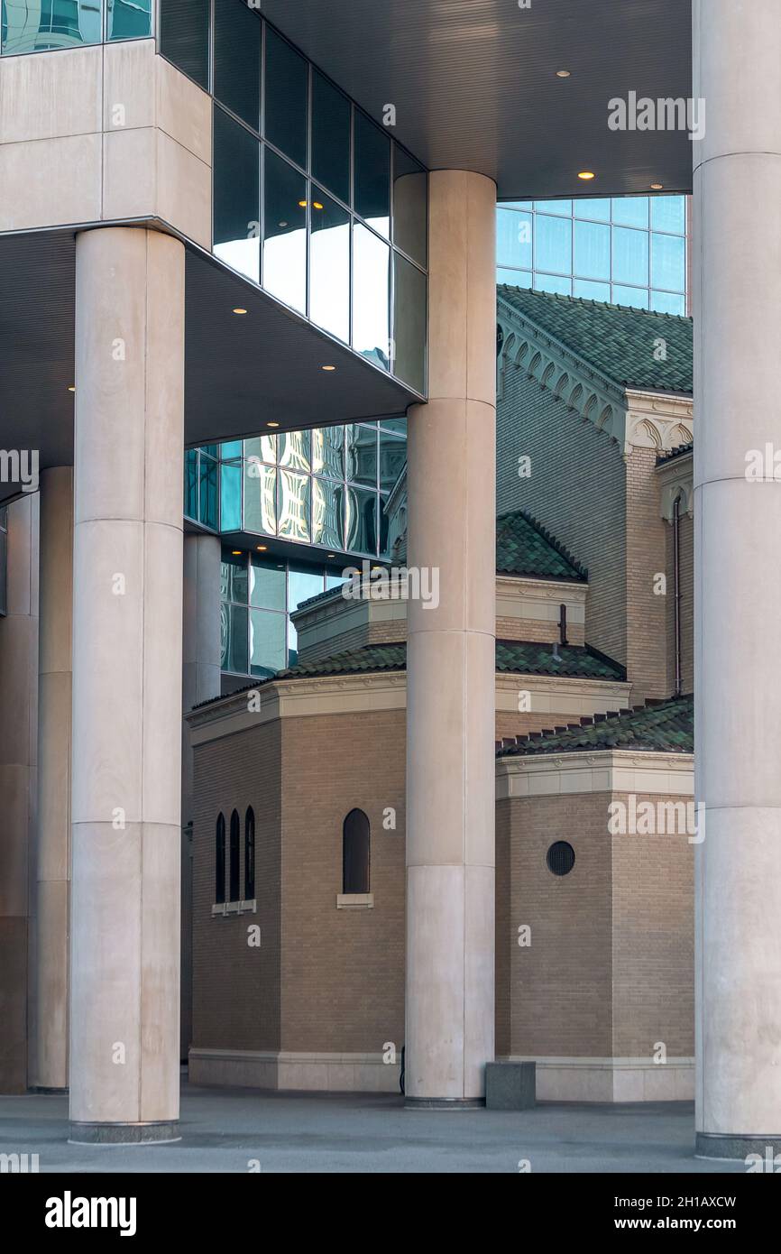 Historic brick Holy Ghost Church in front of a new towering glass ...