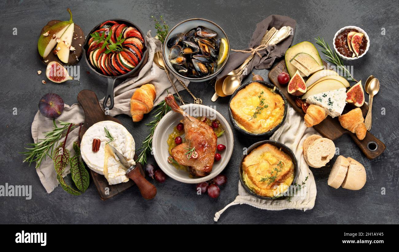 French food assortment on dark background. Traditional cuisine concept ...