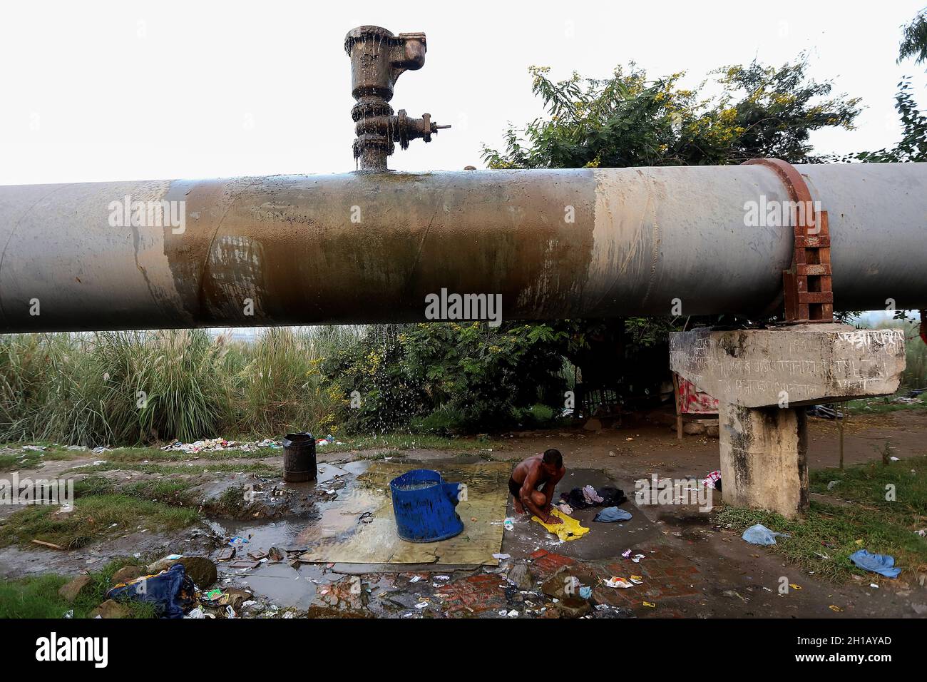 Homeless man washing clothes in hi-res stock photography and images - Alamy