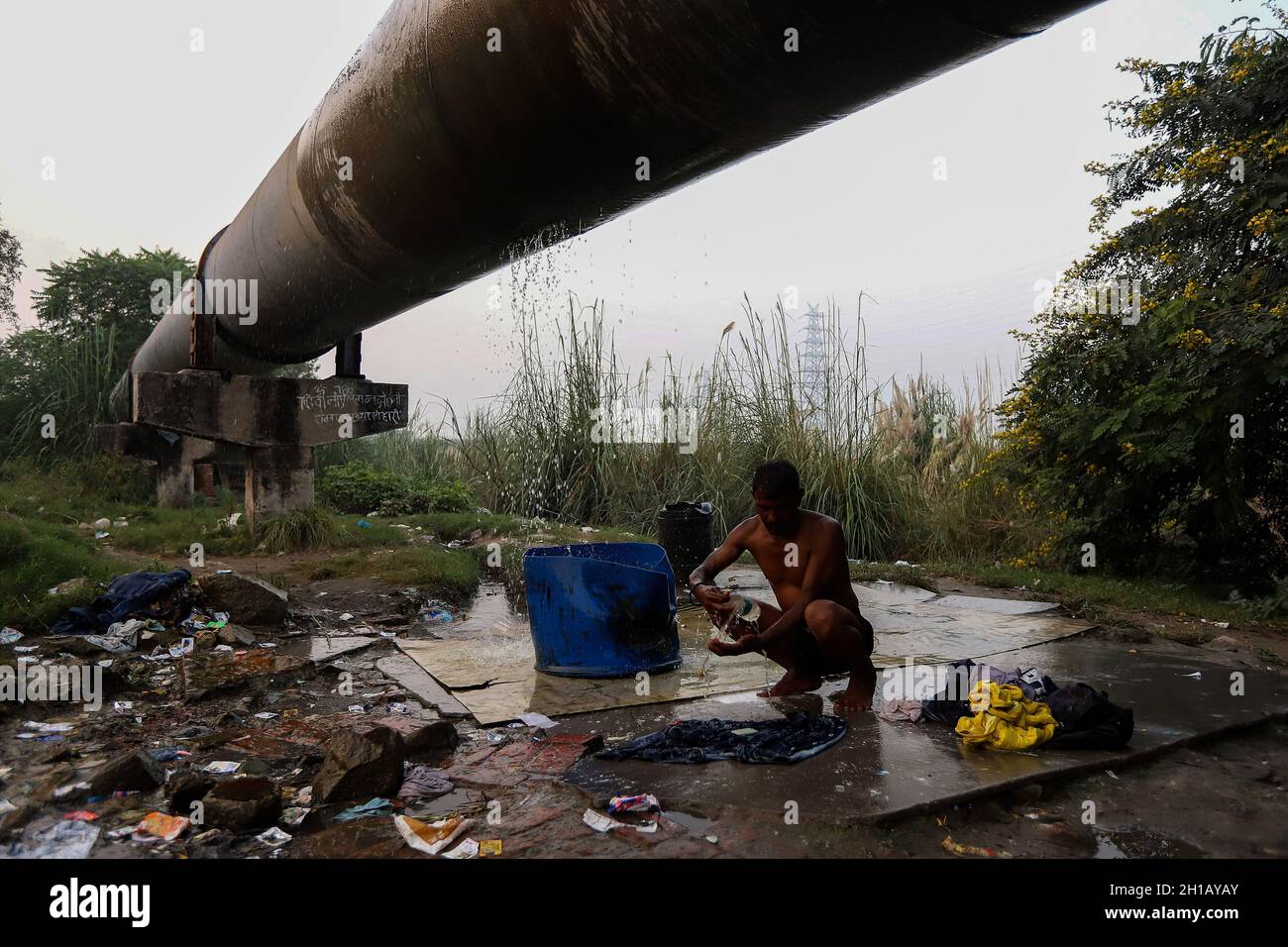 Homeless man washing clothes in hi-res stock photography and images - Alamy