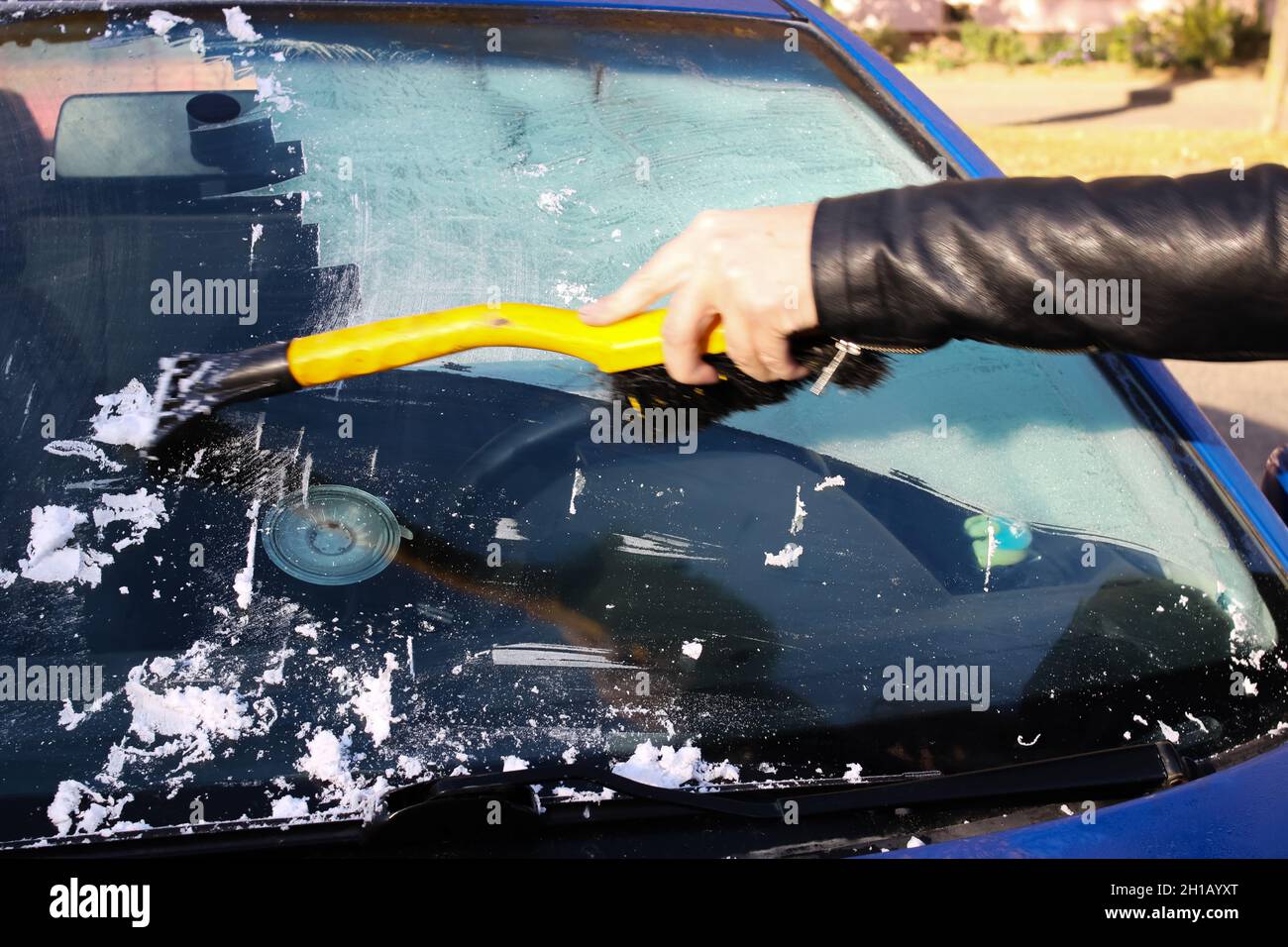 Hand cleans the windshield of a car from ice Stock Photo - Alamy