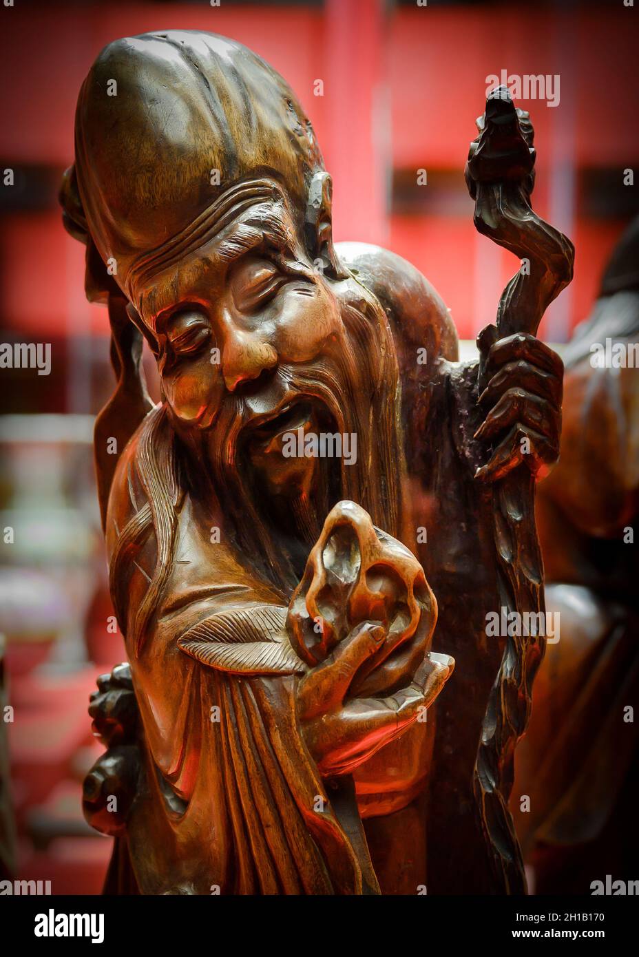 A fragment of a Chinese sculpture of the deity Shou-sin with a peach ...