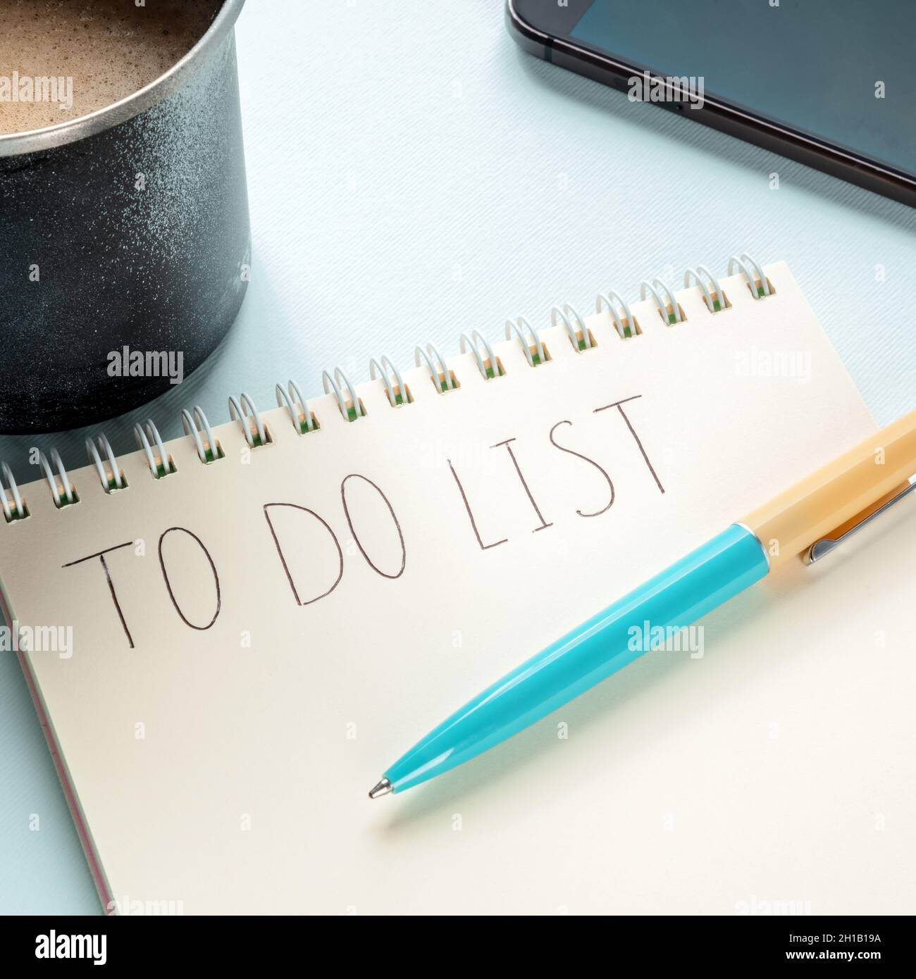 To do list square shot. A spiral notebook with coffee, a ballpoint pen ...