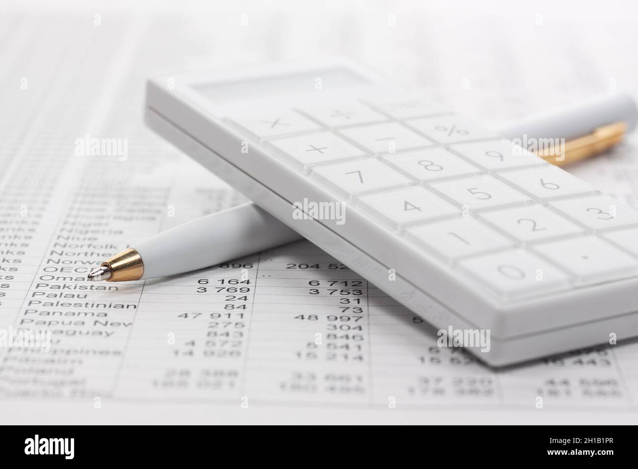 Financial accounting Pen and calculator on balance sheets Stock Photo ...