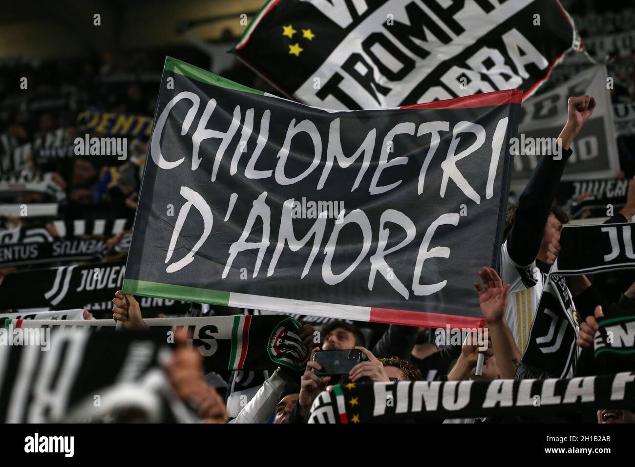 Turin, Italy. 17th Oct, 2021. Juventus fans hold up banners and scarves ...