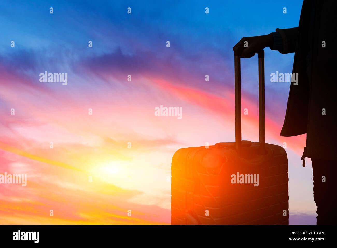 Young woman with suitcase at sunset,Travel concept Stock Photo - Alamy