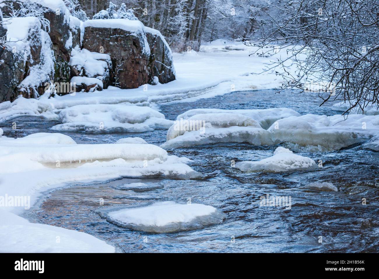 Winter landscape with rocks and a frozen river Stock Photo - Alamy