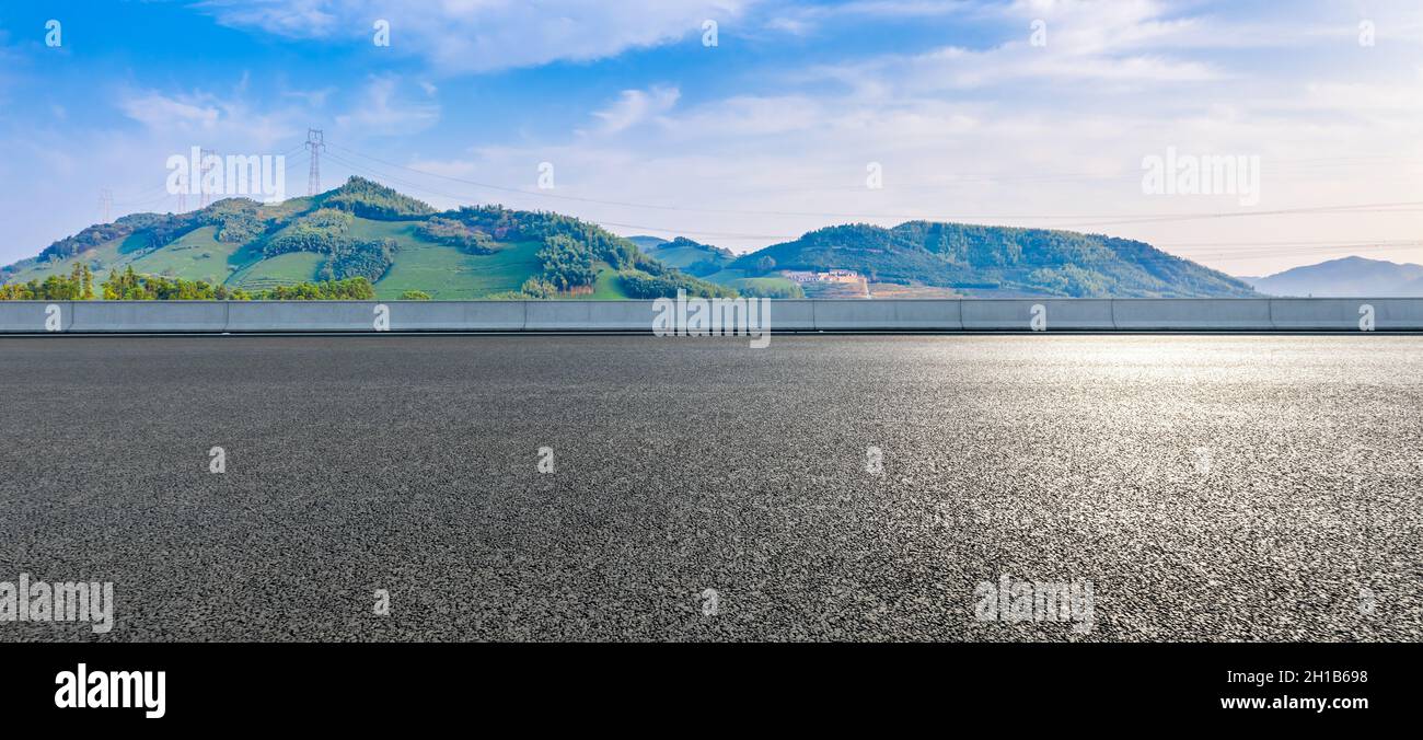 Asphalt highway and green mountain scenery Stock Photo - Alamy