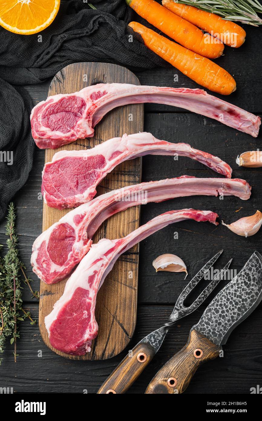 Raw fresh lamb ribs set, with ingredients carrot orange, herbs, on ...