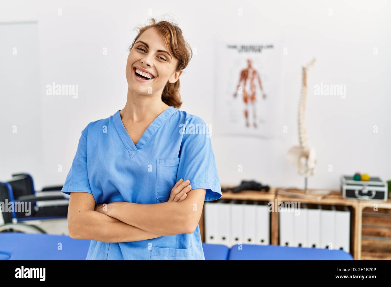 Young caucasian physio therapist girl standing with arms crossed ...