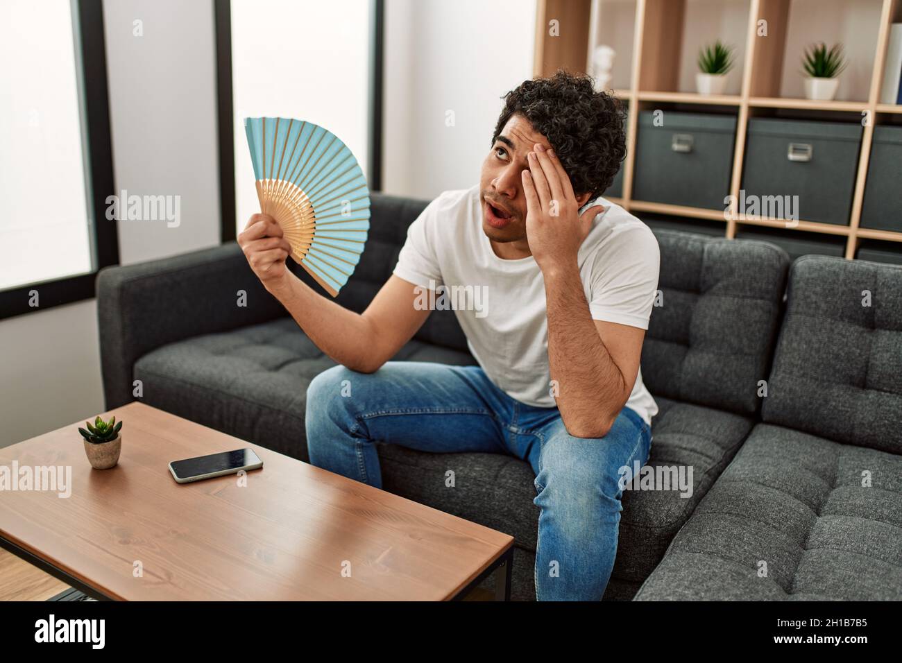 Man holding fan to cool the face hi-res stock photography and images ...