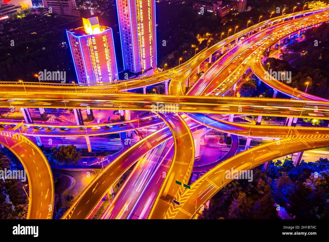Aerial view of buildings and highway interchange at night in Shanghai ...