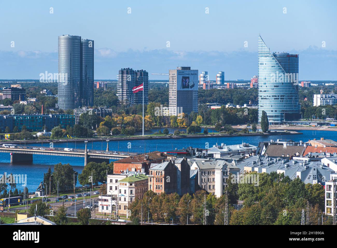 Riga panorama with Daugava river, bridge, flag of Latvia and ...