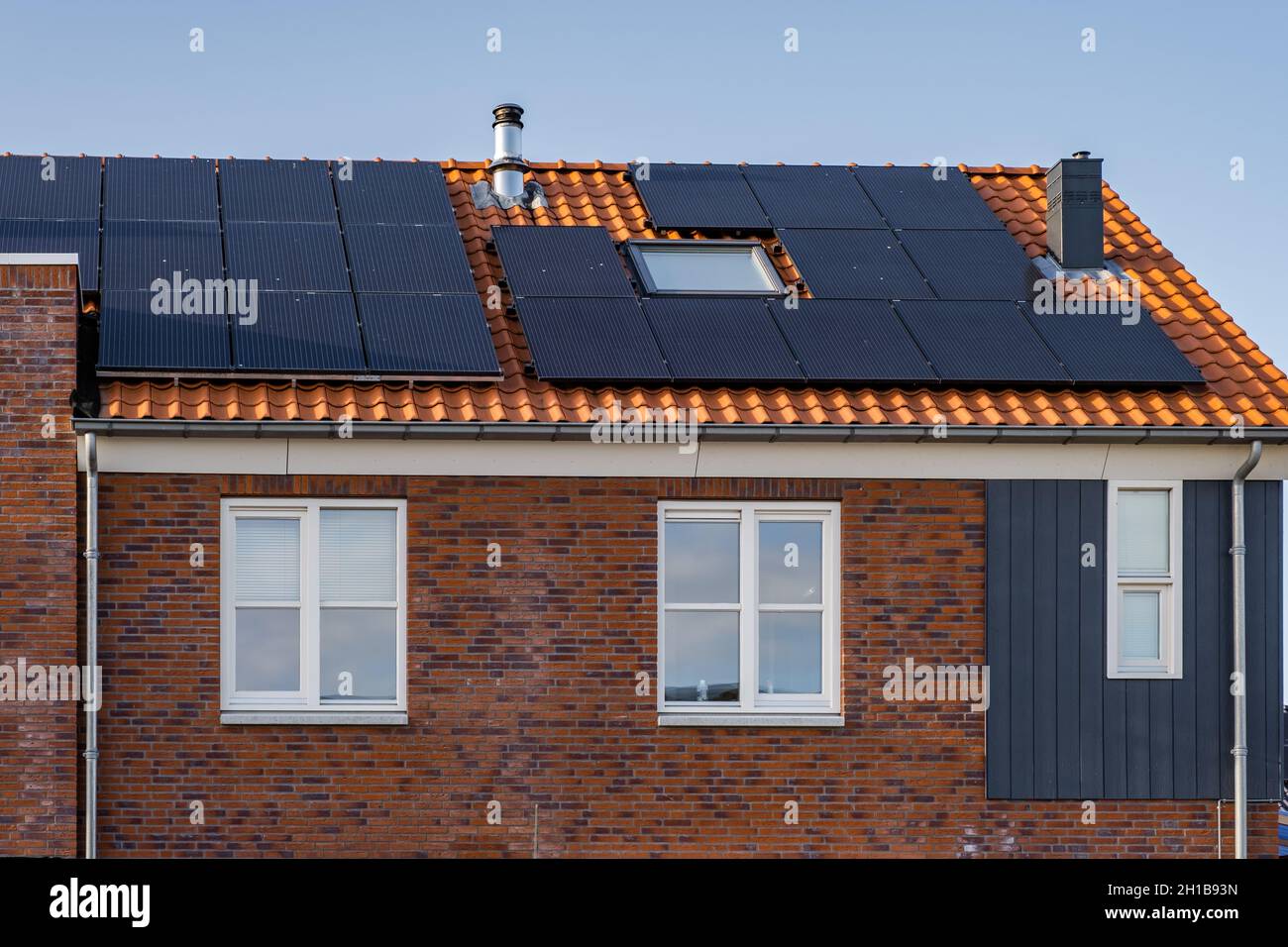 Newly build houses with solar panels attached on the roof against a ...