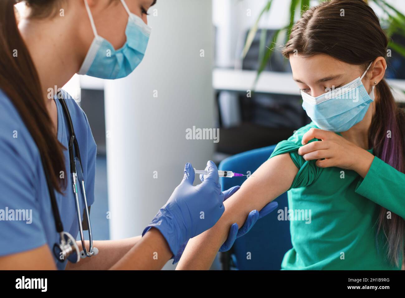 Teen Girl Receiving Vaccine Injection In Arm In Medical Centre Stock ...