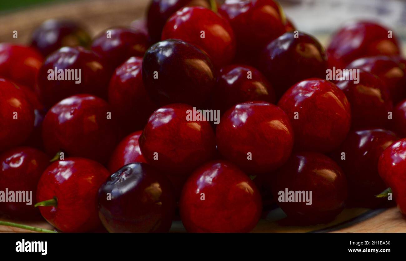Closeup shot of fresh and natural cherries set on a plate Stock Photo ...