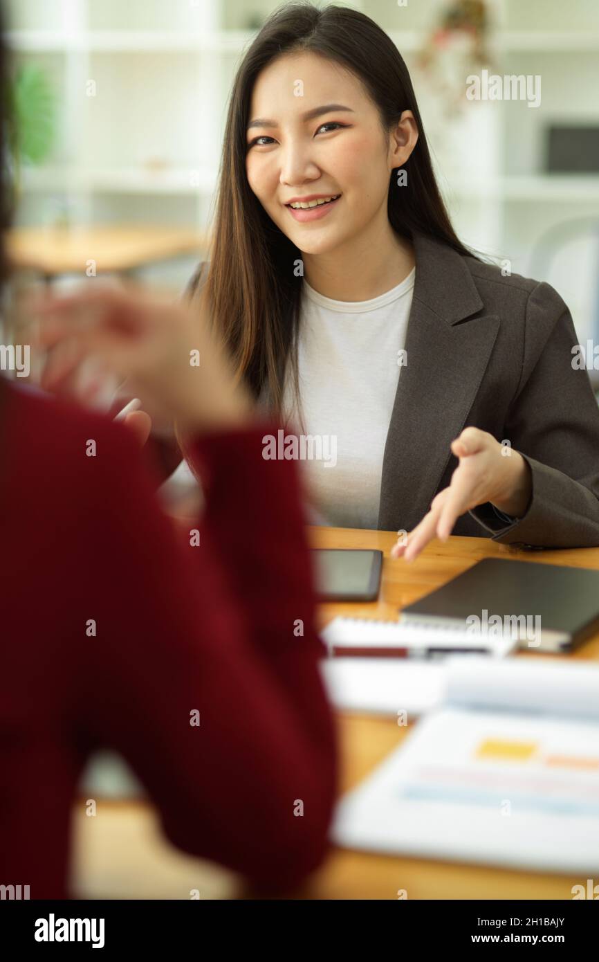 Attractive young asian businesswoman mentor coaching to her new ...
