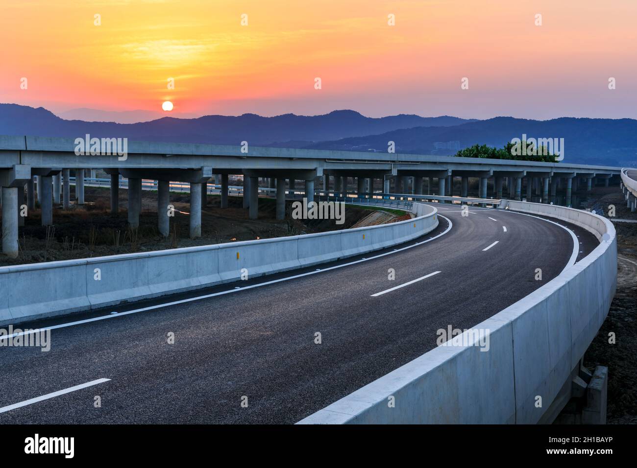 Asphalt highway and mountain landscape at sunset,road pavement ...