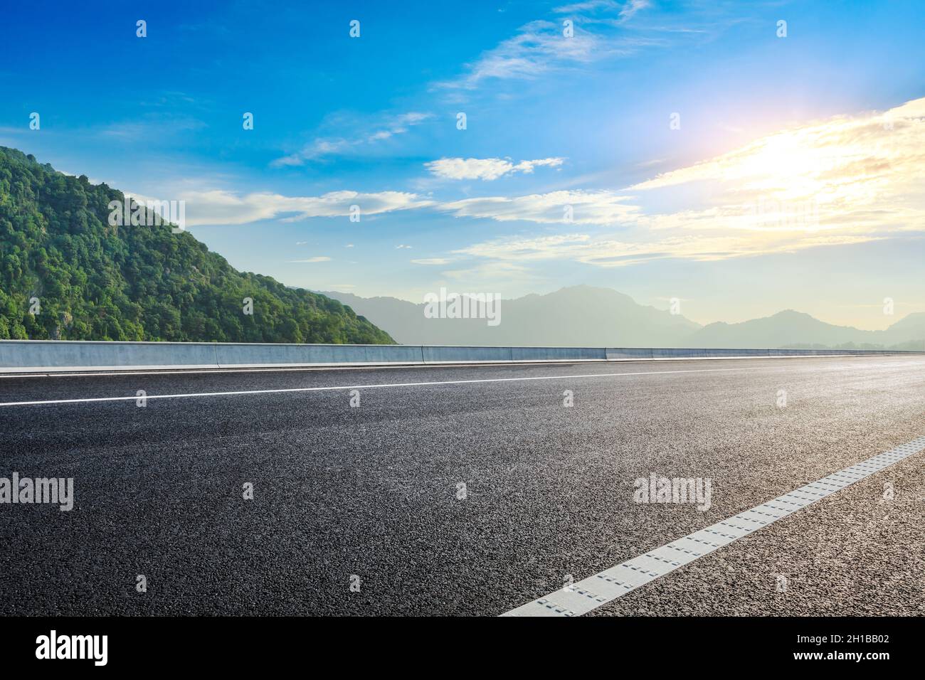 Asphalt highway and mountain landscape at sunset,road pavement ...