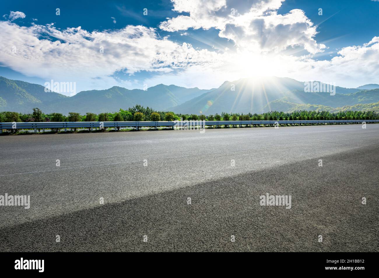 Asphalt highway and mountain landscape at sunset,road pavement ...