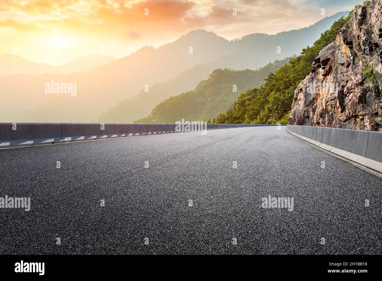 Asphalt highway and mountain landscape at sunset,road pavement ...