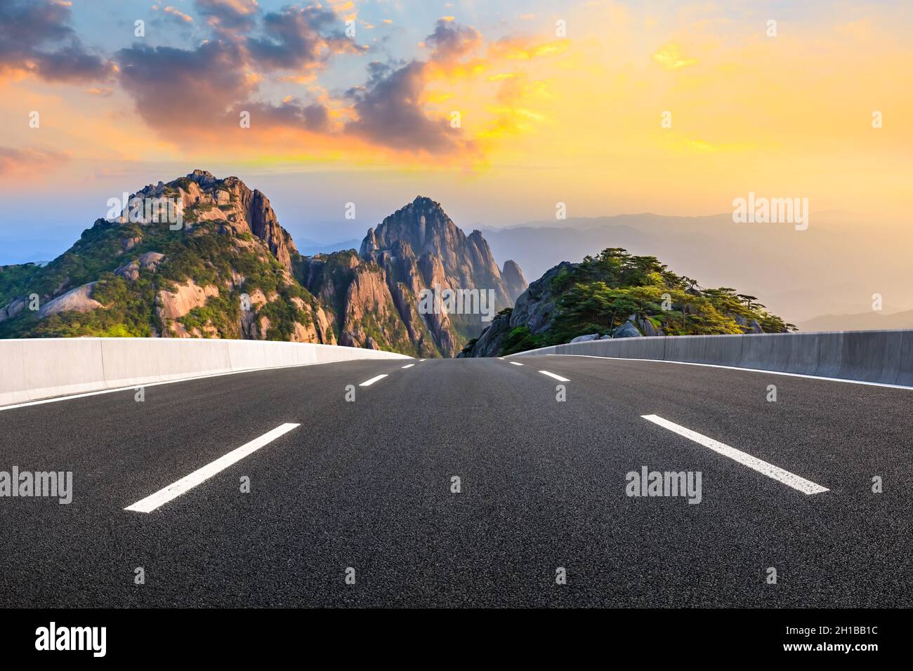 Asphalt highway and mountain landscape at sunset,road pavement ...