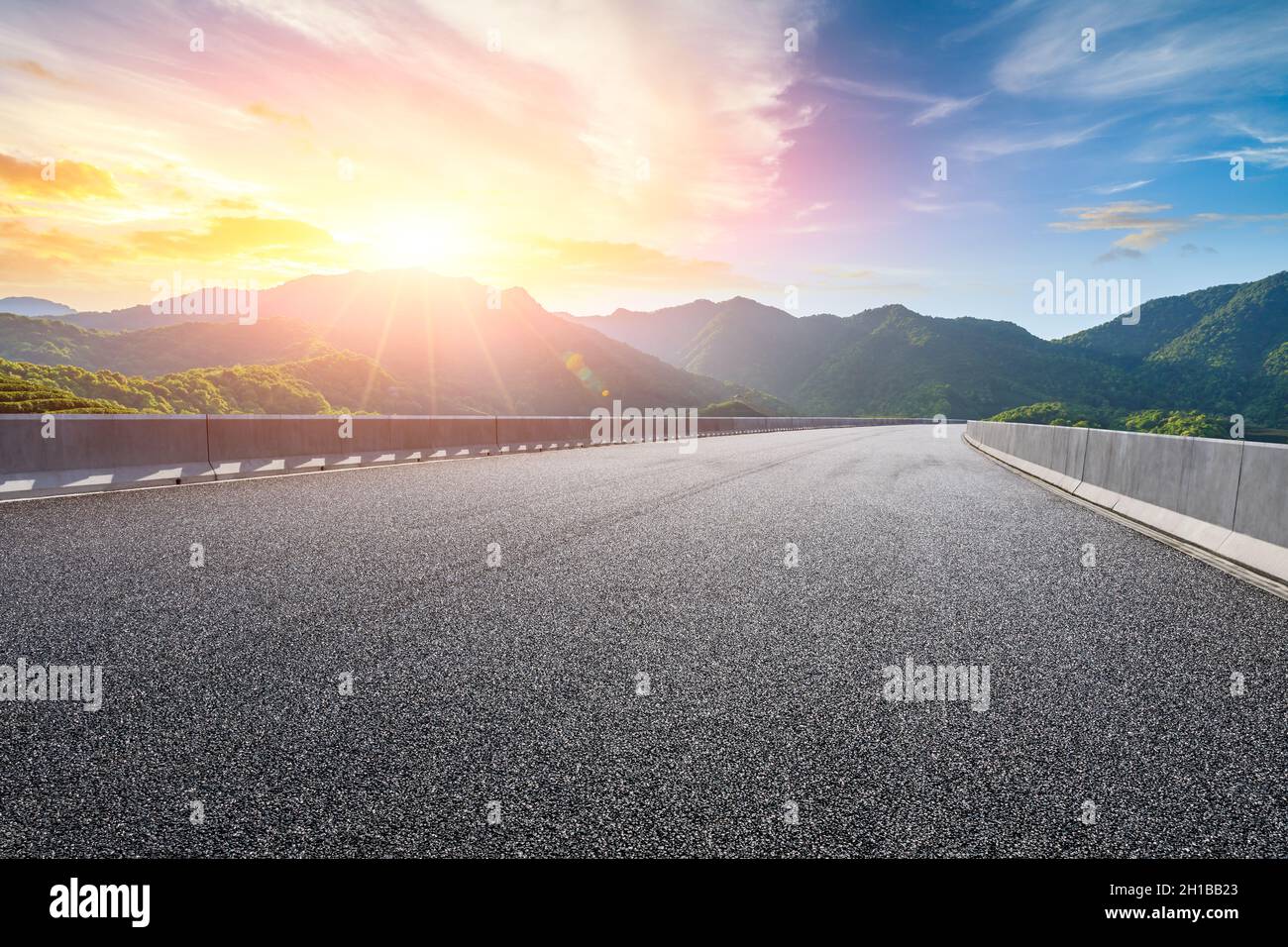 Asphalt highway and mountain landscape at sunset,road pavement ...