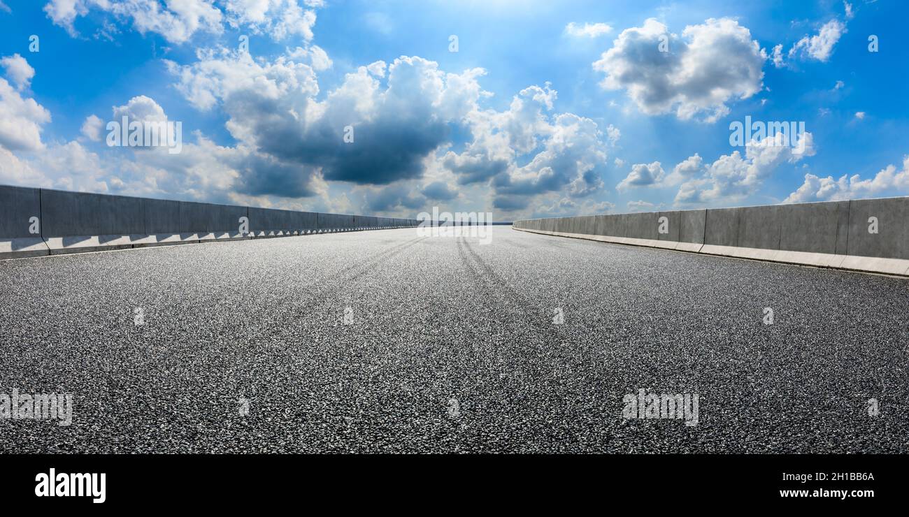 Asphalt highway ground and blue sky with white clouds scene Stock Photo ...