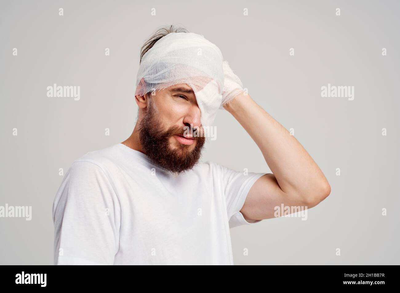 bearded man head injury in white t-shirt headache hospital medicine ...