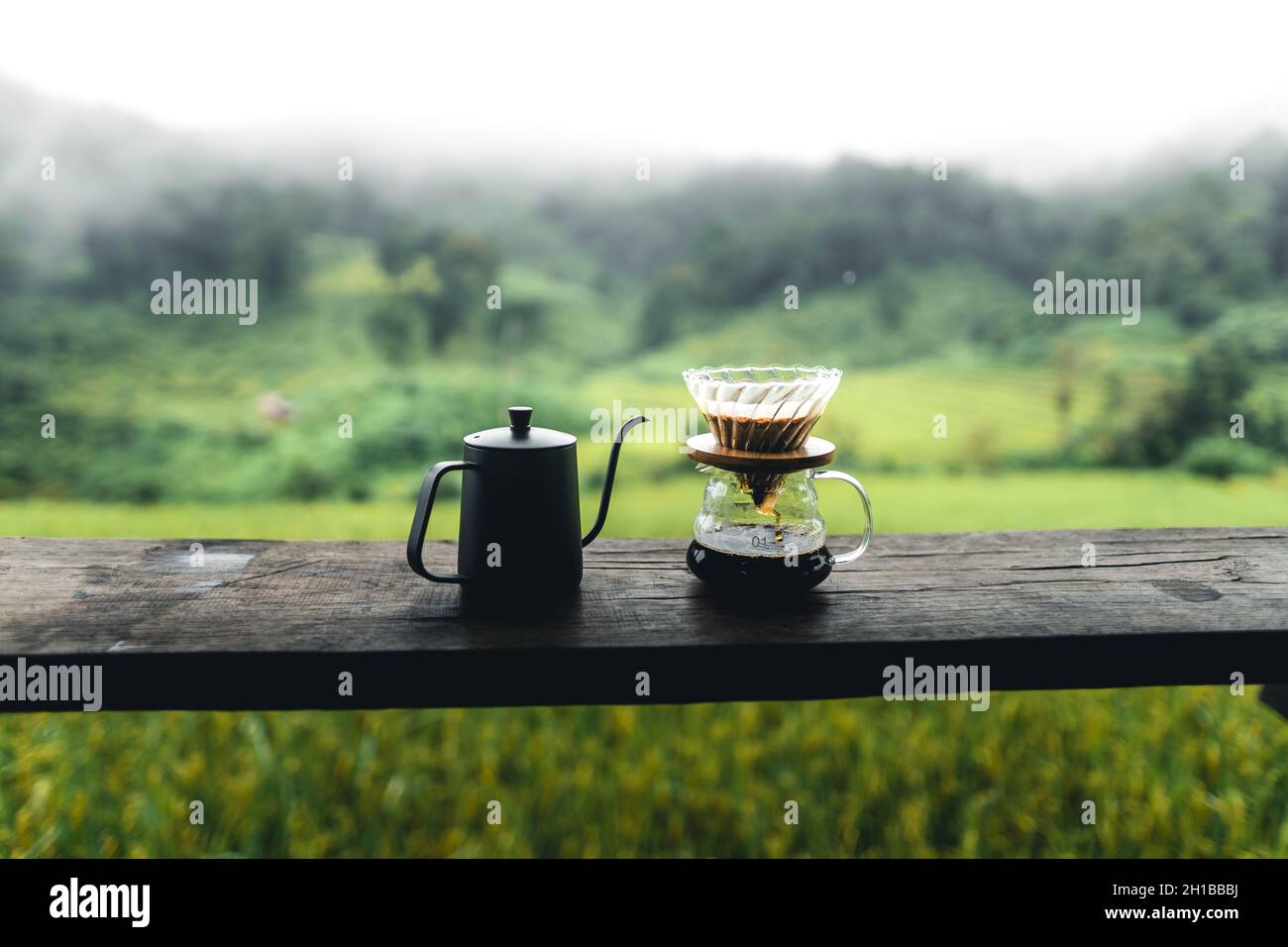 outdoor drip coffee maker on wooden table rice field background Stock ...